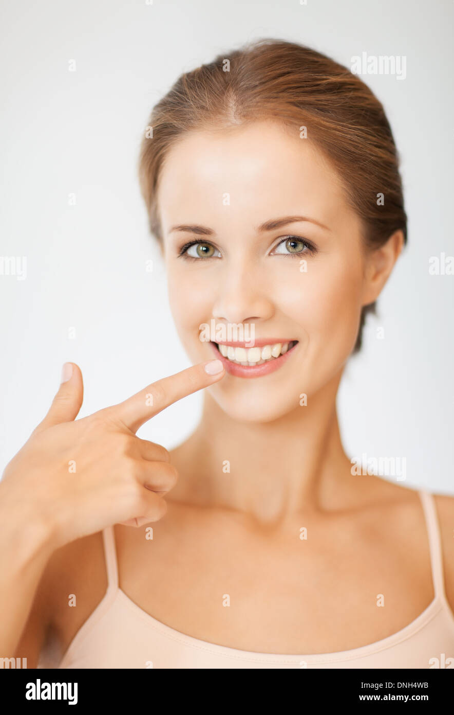beautiful woman pointing to teeth Stock Photo - Alamy