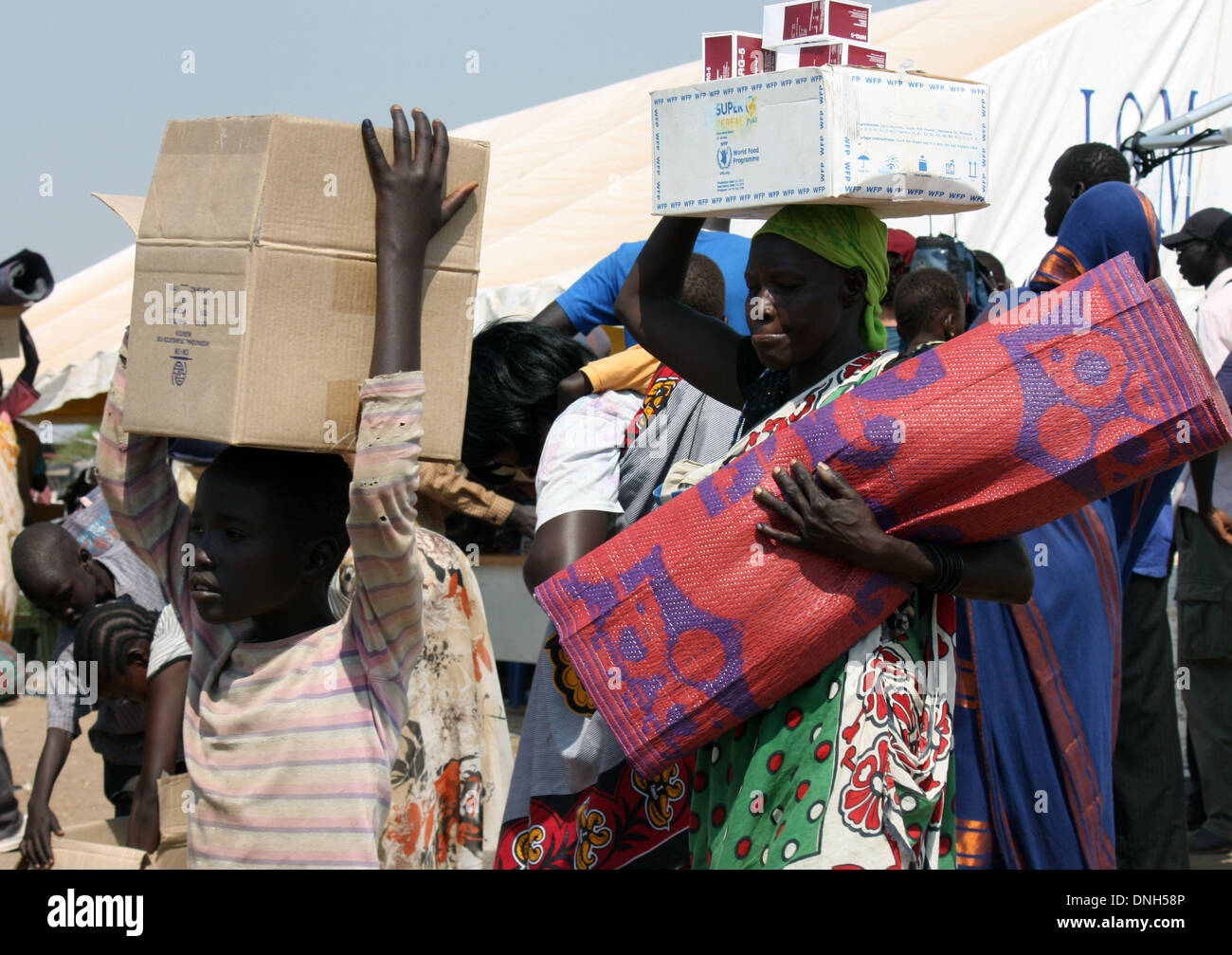 Khartoum, South Sudan. 29th Dec, 2013. South Sudanese refugees carry ...