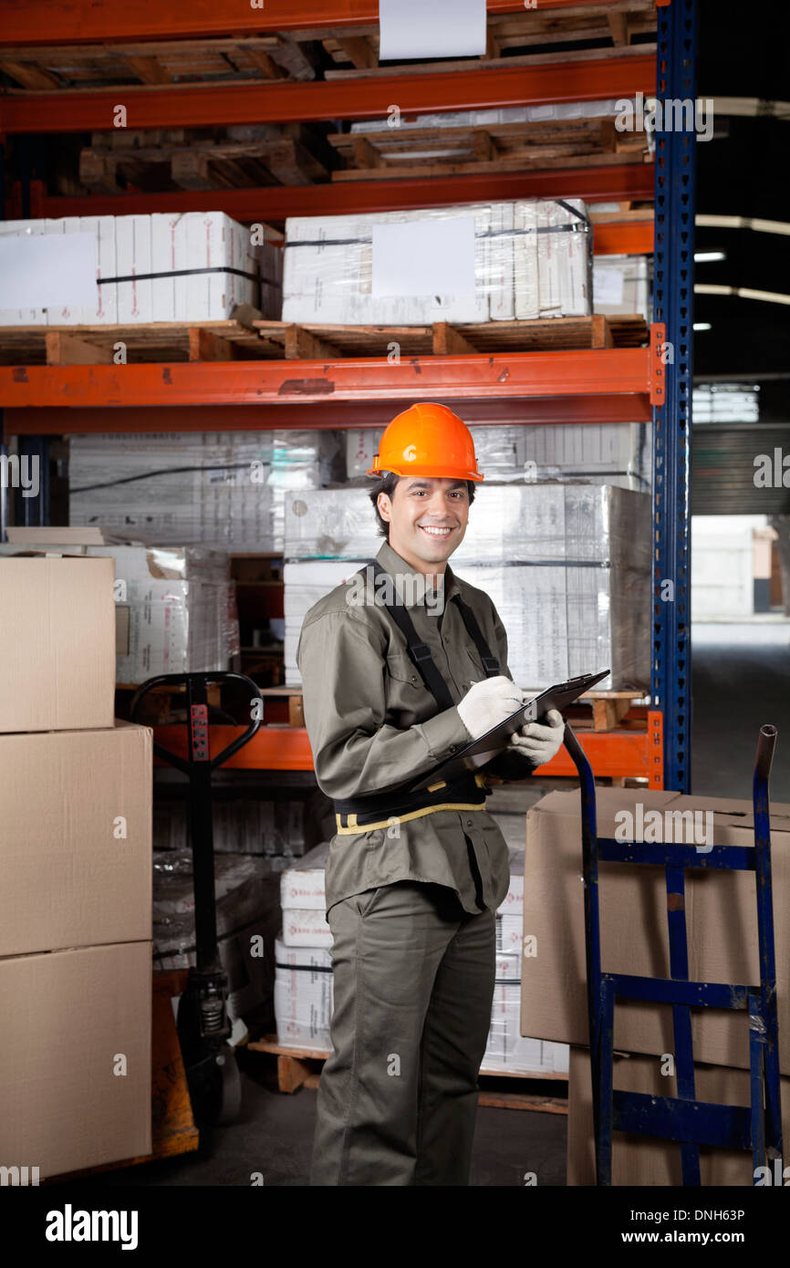 Supervisor Writing On Clipboard At Warehouse Stock Photo - Alamy