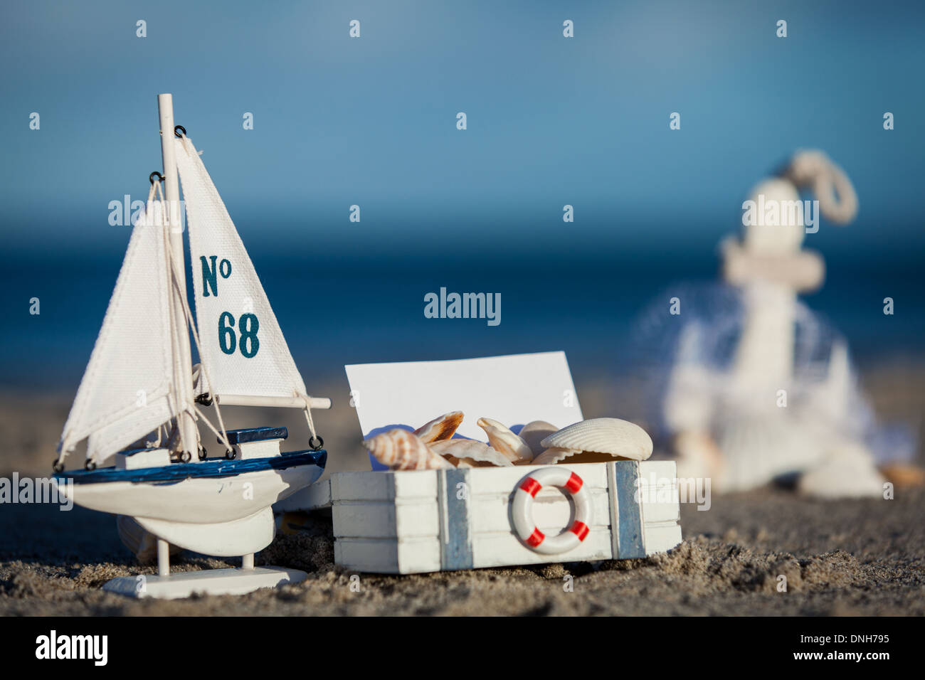 sailing boat and seashell in sand decoration closeup holiday background ...