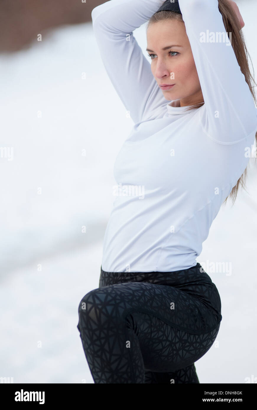 A beautiful woman stretches before a run on a cold winter day Stock ...