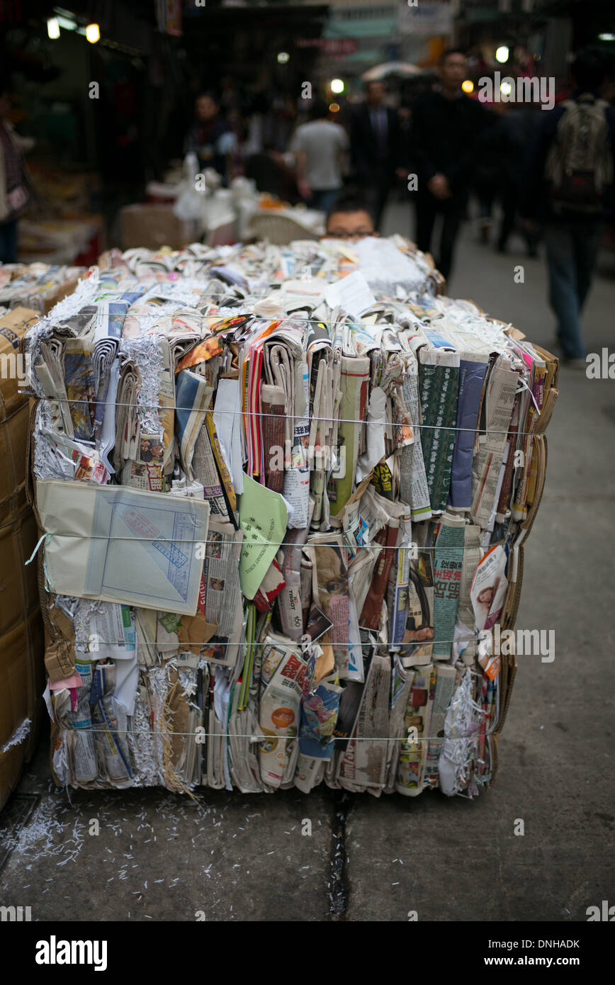 A large block of old newspapers is packed ready for recycling in one of ...