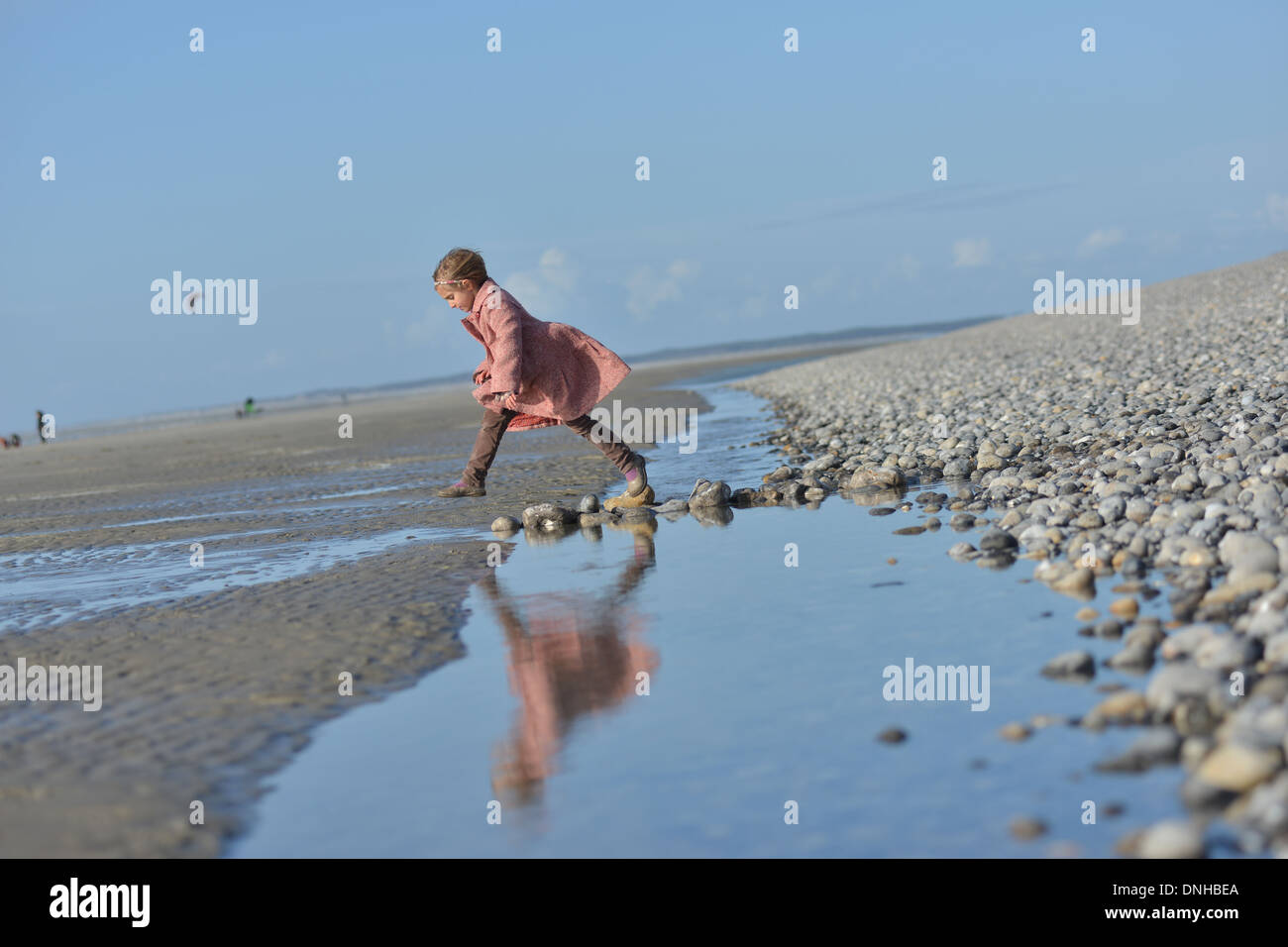 LITTLE GIRL ON A SHINGLE BEACH IN CAYEUX-SUR-MER, SOMME, PICARDY ...