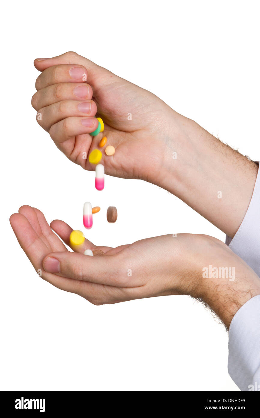 pill in a hand isolated on white background Stock Photo - Alamy