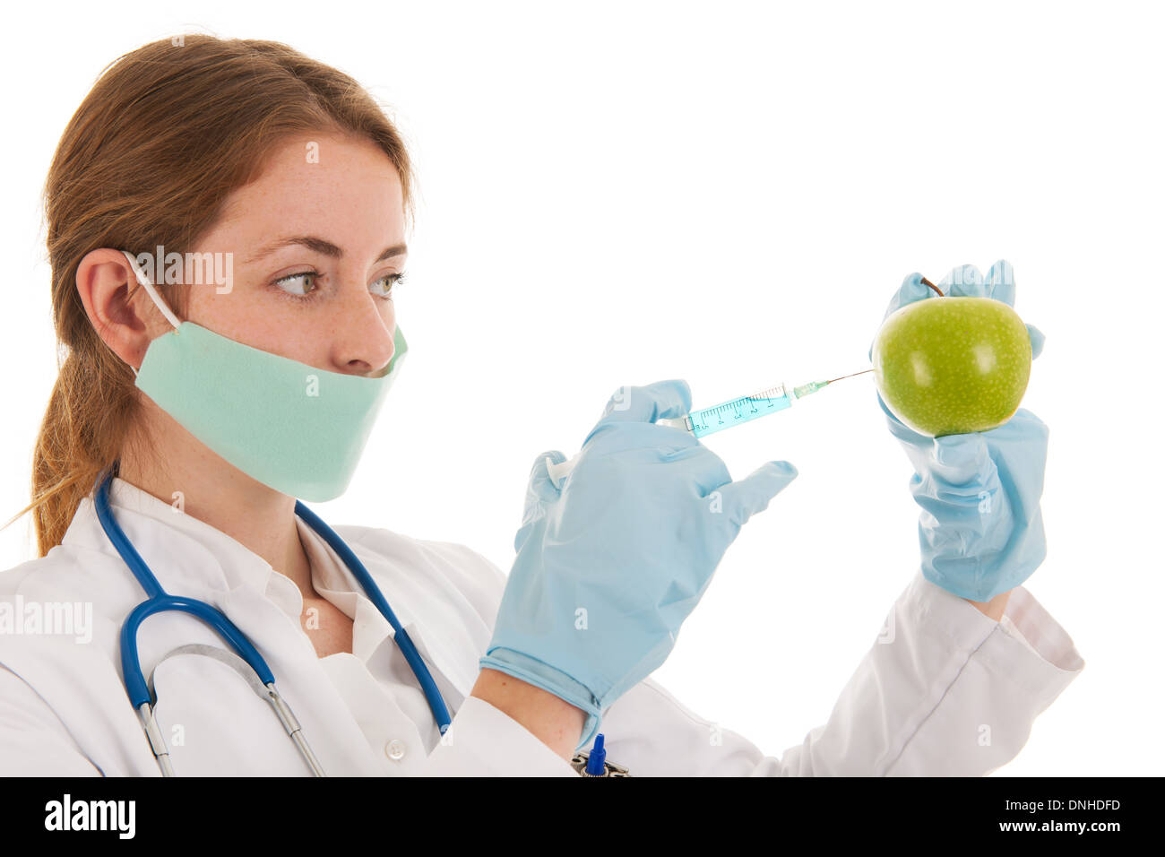 Doctor with syringe full of medicine for healthy apple isolated over ...