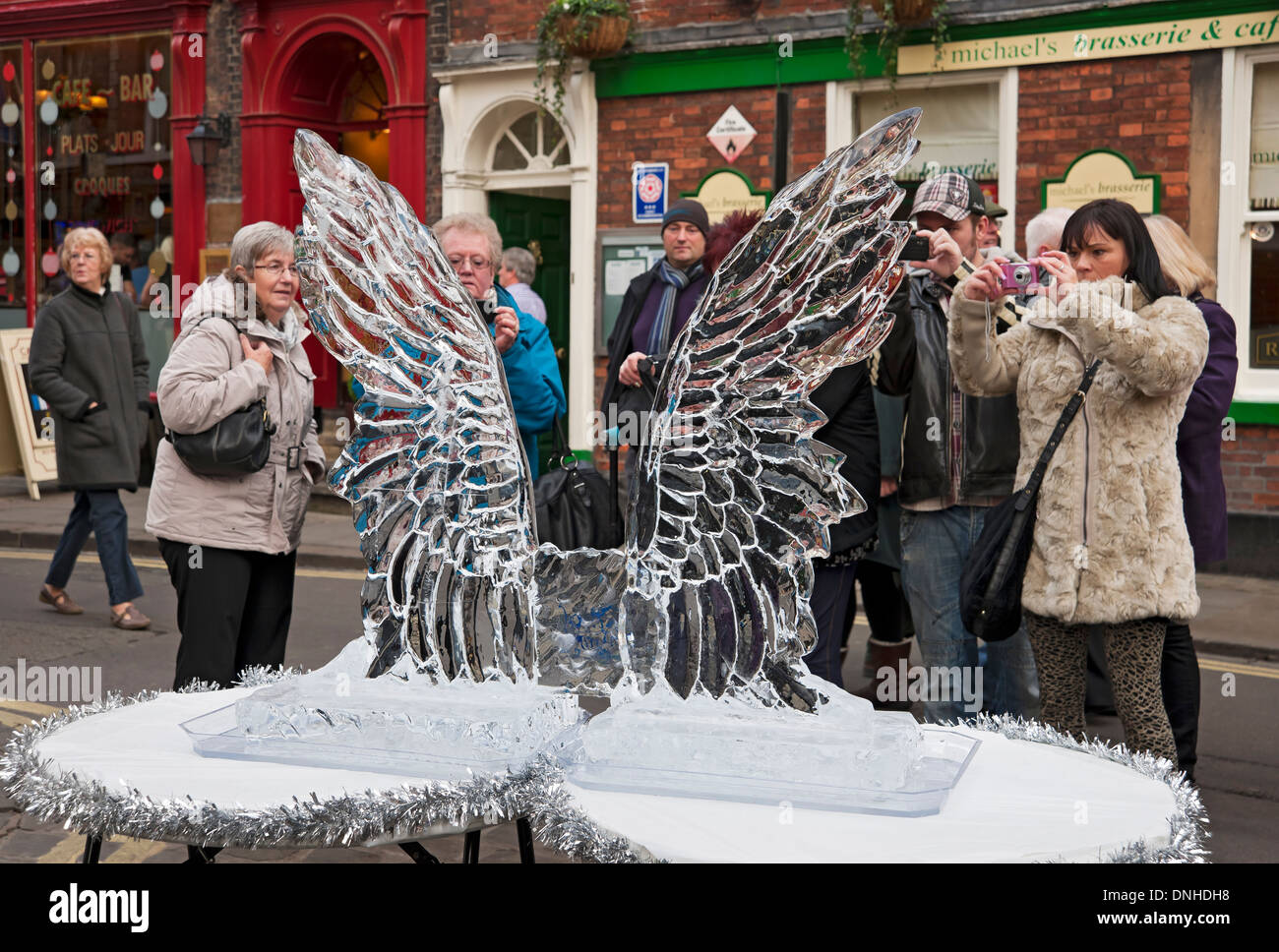 People taking photos pictures of Ice sculpture of angel wings at the ...