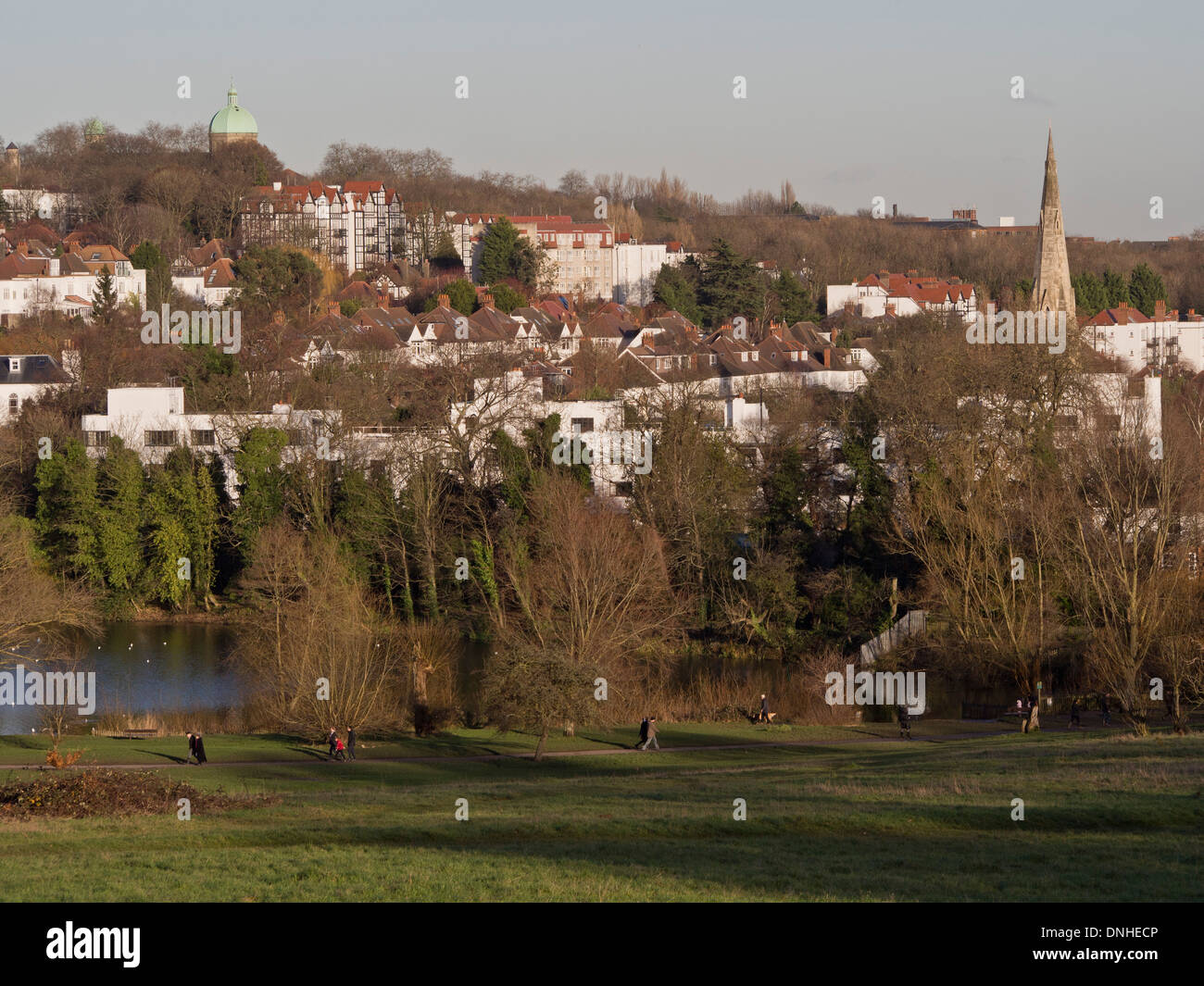 People walking on Hampstead Heath, with Highgate village in background ...