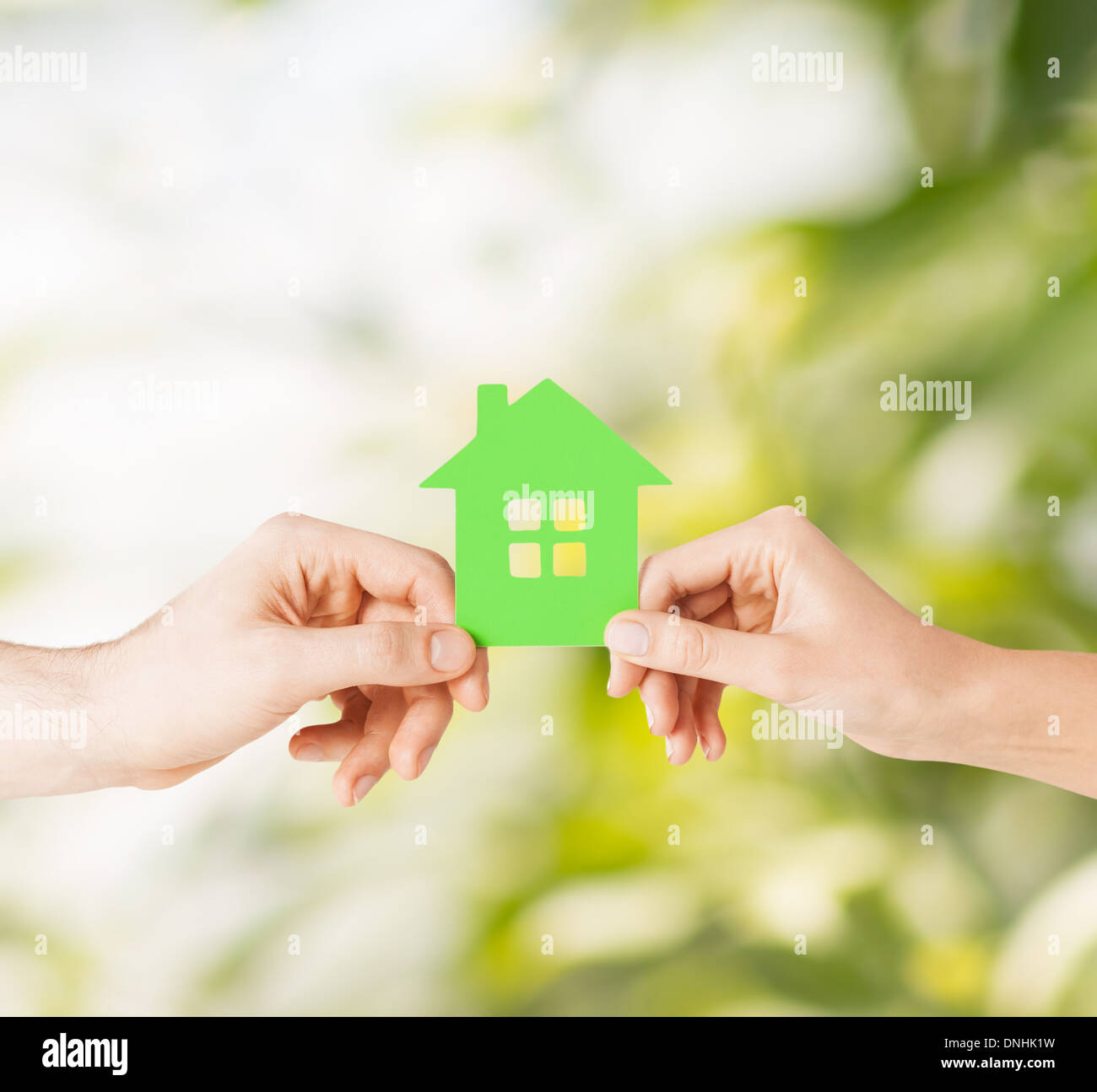 couple hands holding green house Stock Photo - Alamy