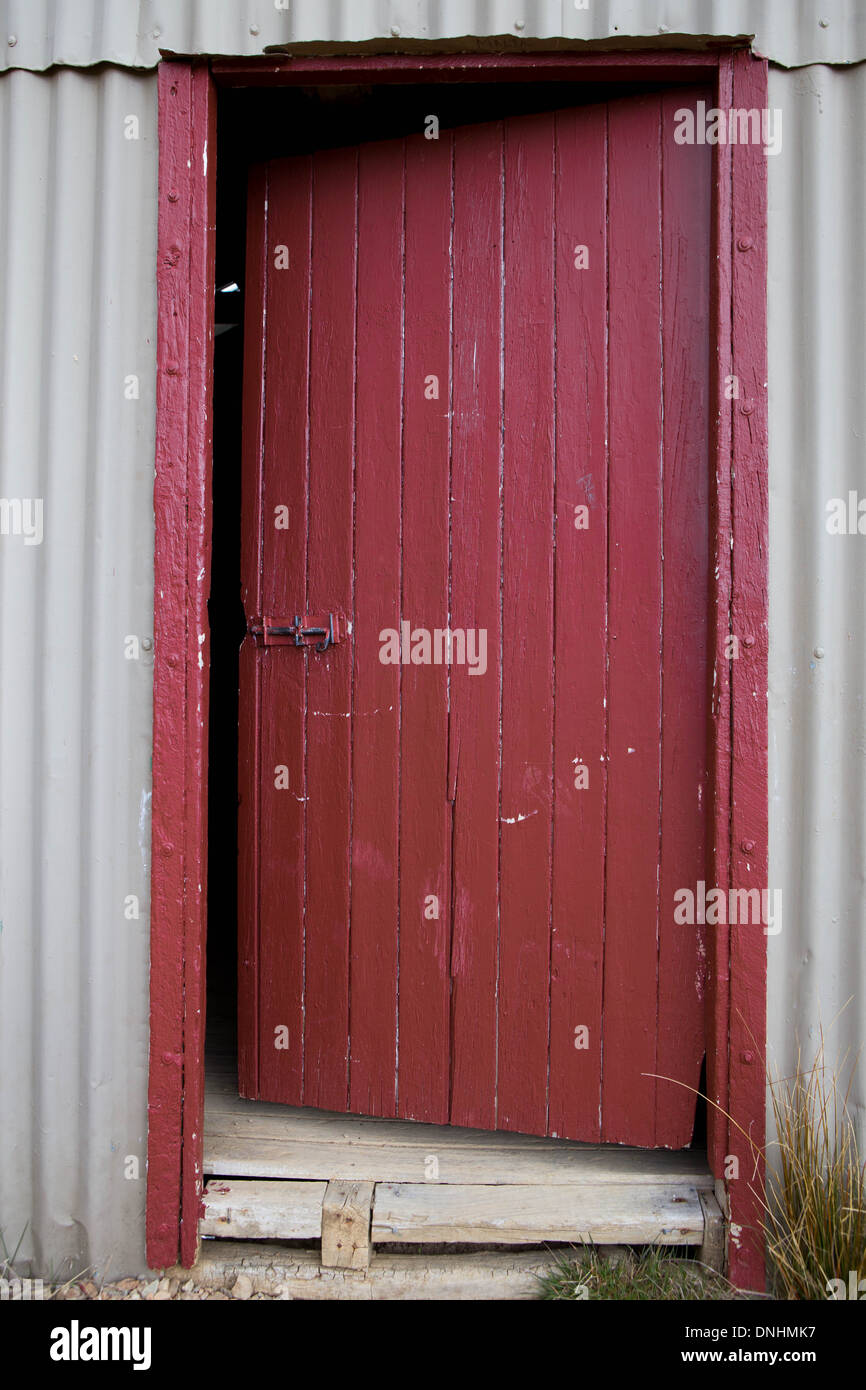 Slightly open red wooden door Stock Photo - Alamy