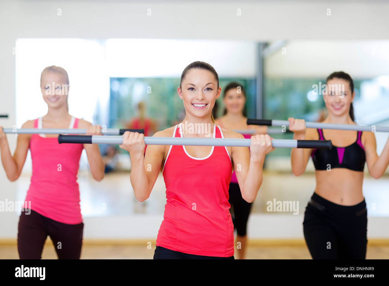 group of smiling people working out with barbells Stock Photo - Alamy