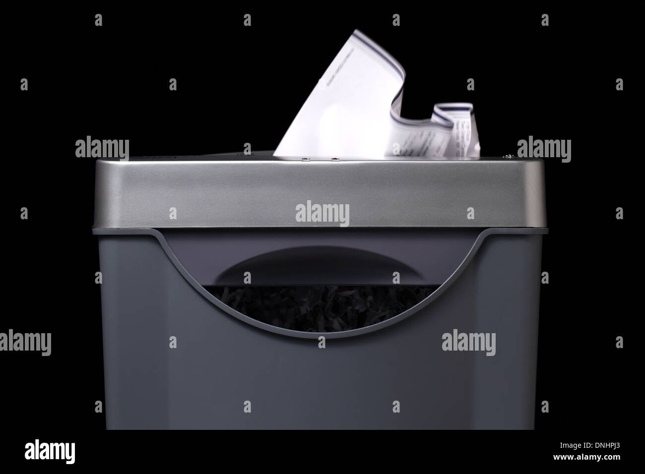 A close-up view of a paper shredder with paper going inside Stock Photo ...
