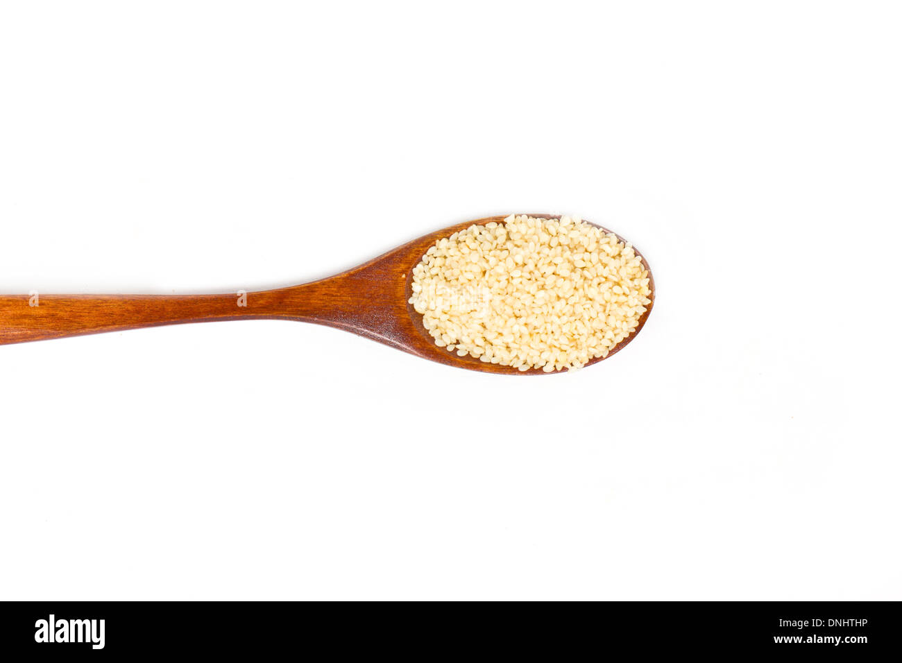 Sesame seeds on wooden spoon isolated on white background Stock Photo ...