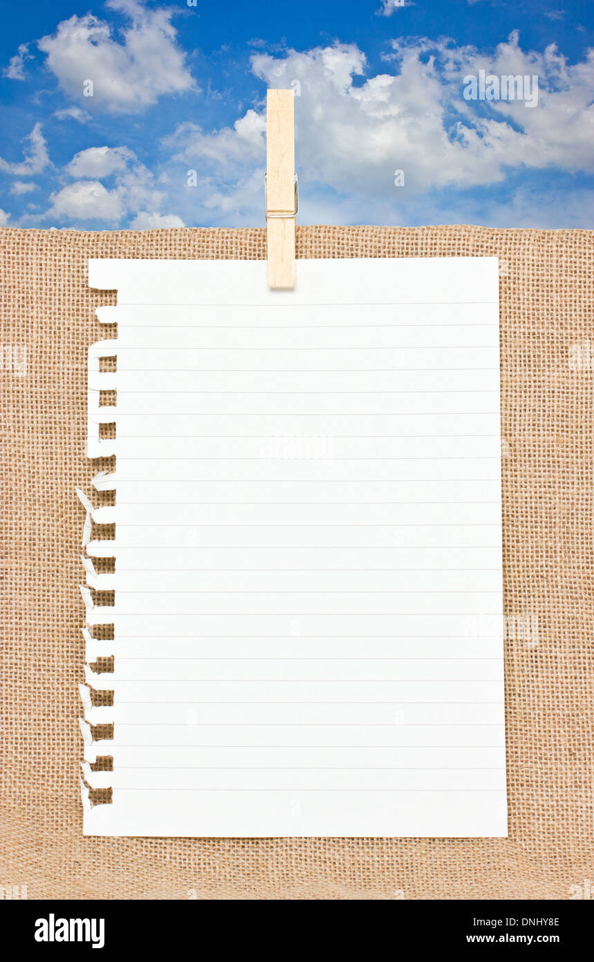 Ripped off paper with wooden clothespin on burlap Stock Photo - Alamy