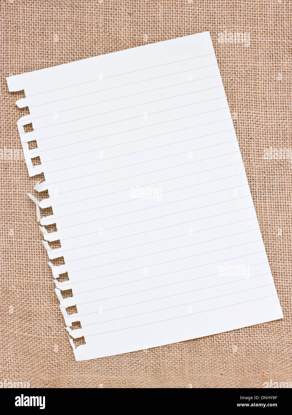 Ripped off paper with burlap backdrop Stock Photo - Alamy