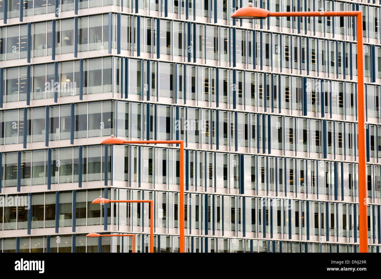 Orange lamp posts with office block backdrop Stock Photo - Alamy