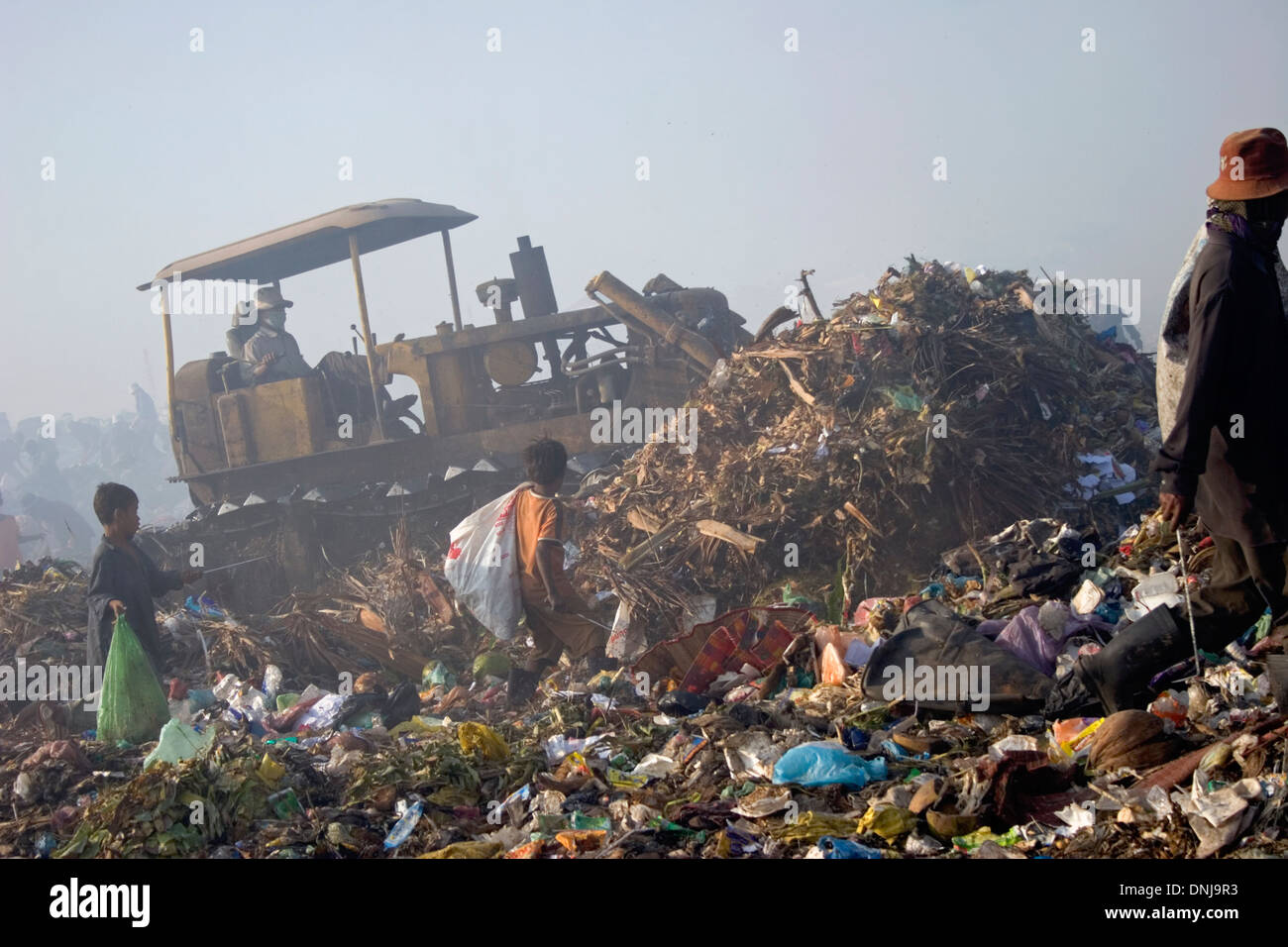 People, including child laborers, are collecting recyclable material at ...