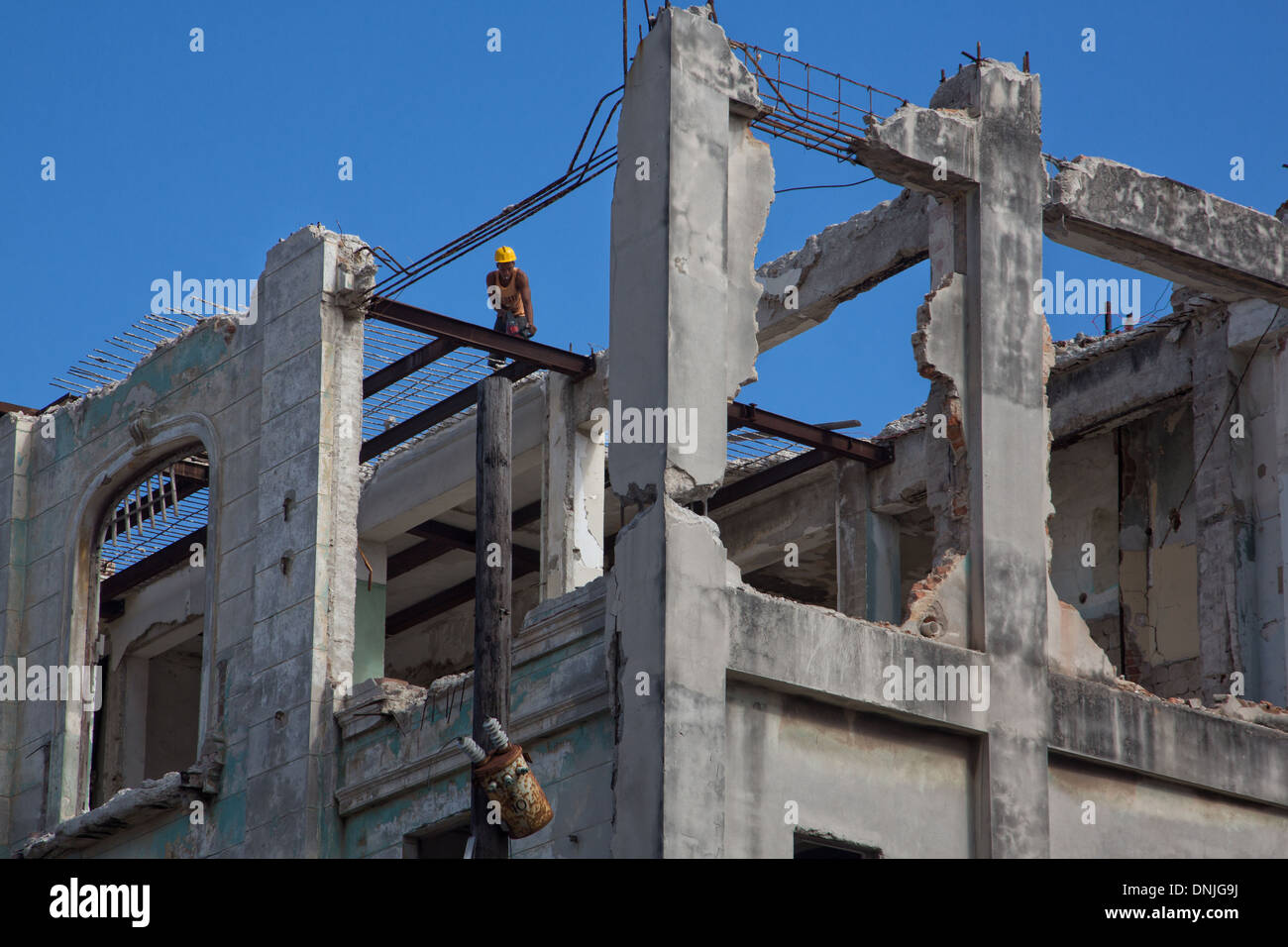 WORKMAN AT WORK IN A BUILDING UNDERGOING RENOVATION, HAVANA, CUBA, THE ...