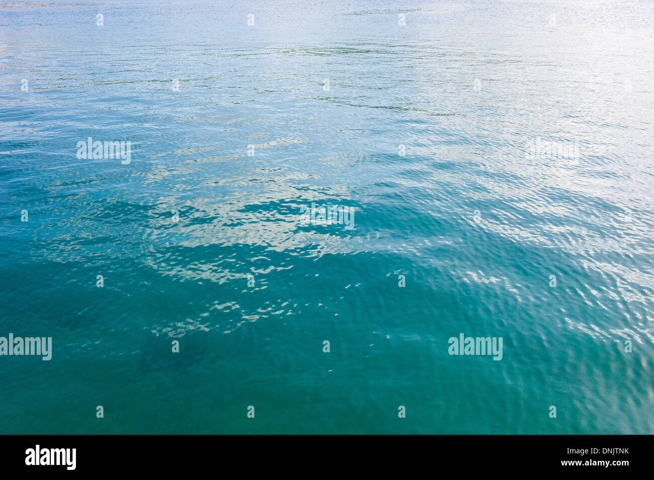 Clear turquoise blue sea water with ripples Stock Photo - Alamy