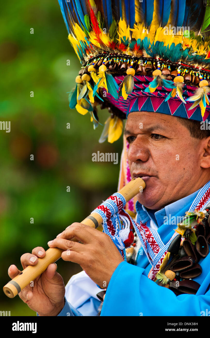 A Colombian Kamentsá shaman, wearing a colorful feather headgear, plays ...