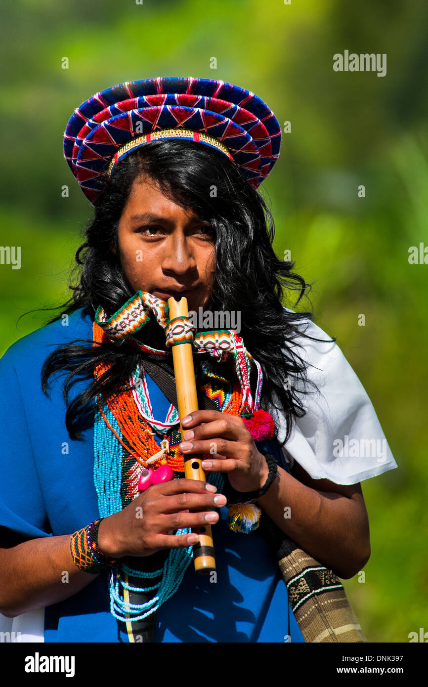 A native from the Kamentsá tribe, wearing a colorful headgear, plays ...