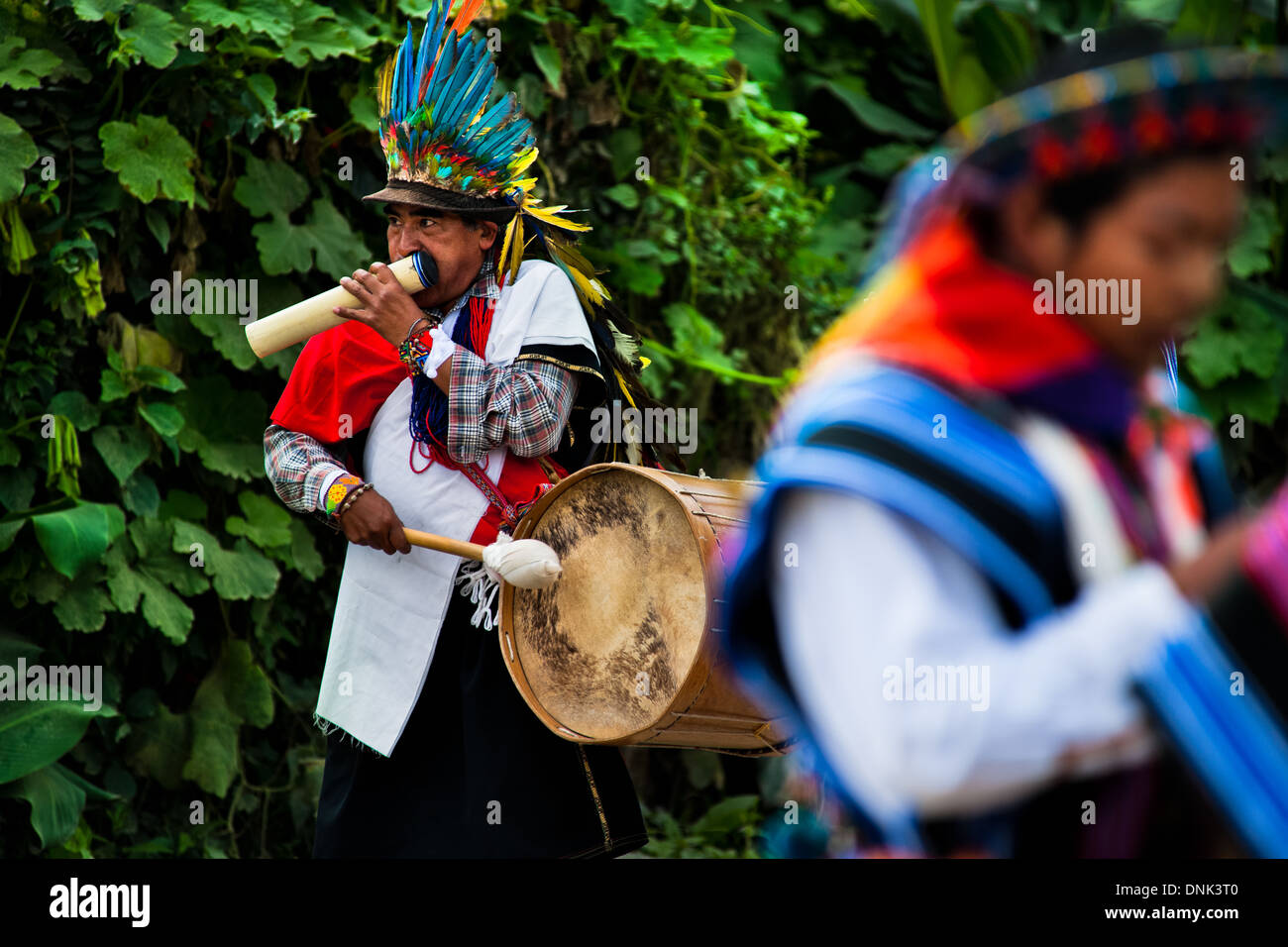 A native from the Kamentsá tribe, wearing a colorful headgear, plays ...