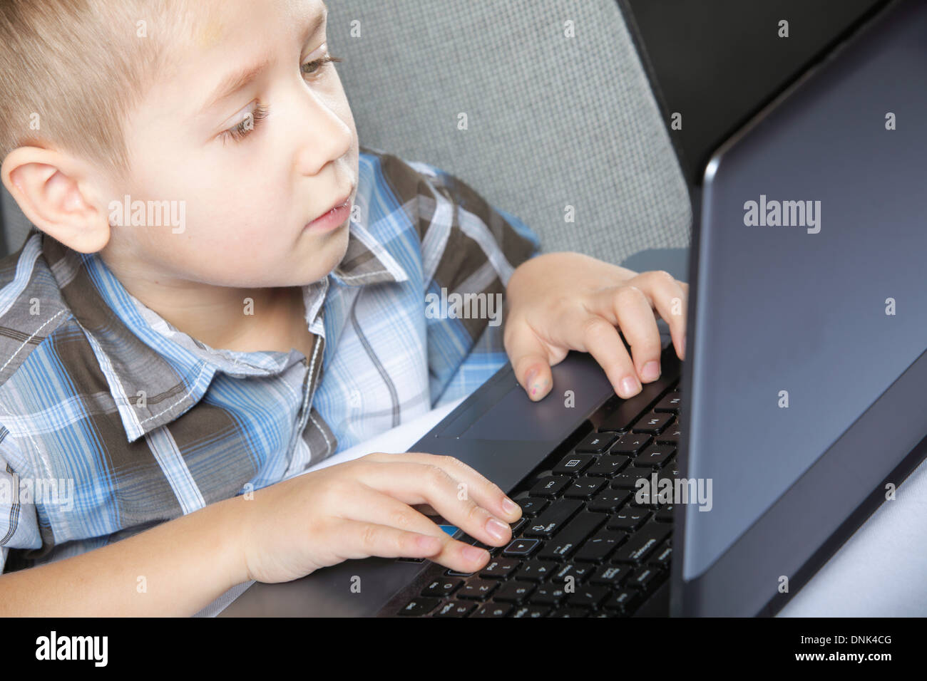 Computer addiction child boy with laptop notebook black background ...