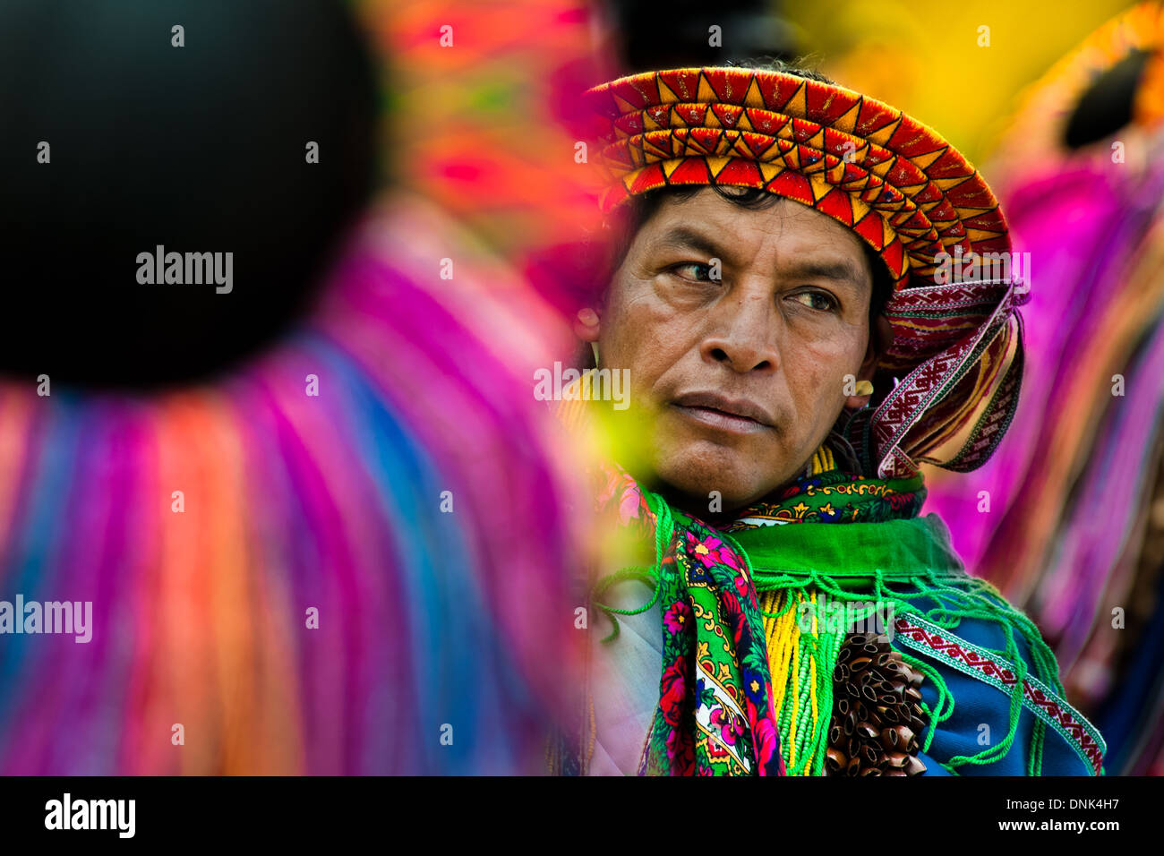 A Colombian Kamentsá native, wearing a colorful headgear, takes part in ...