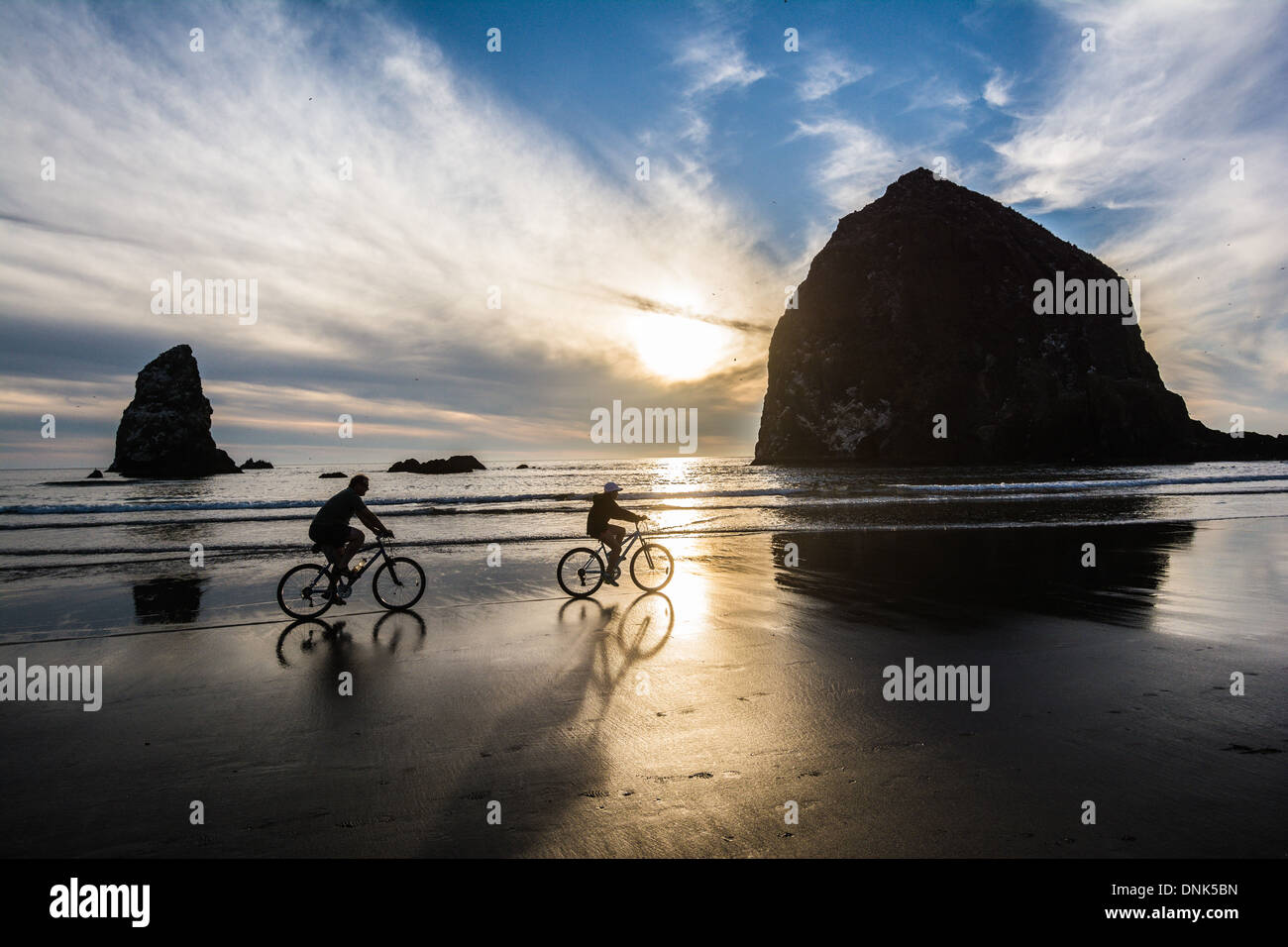 Father & son riding bicycles near Haystack Rock & The Needles, Cannon ...