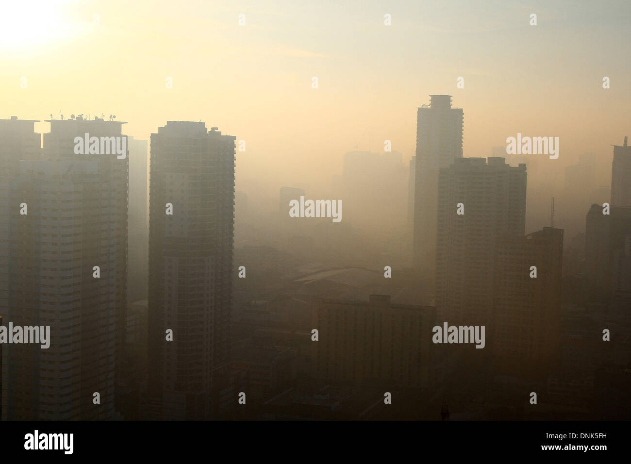 Manila, Philippines. 1st January 2014. Skyscrapers are blanketed in ...