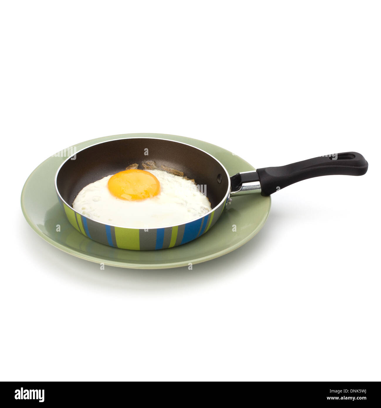 Fried egg on pan over white background Stock Photo - Alamy