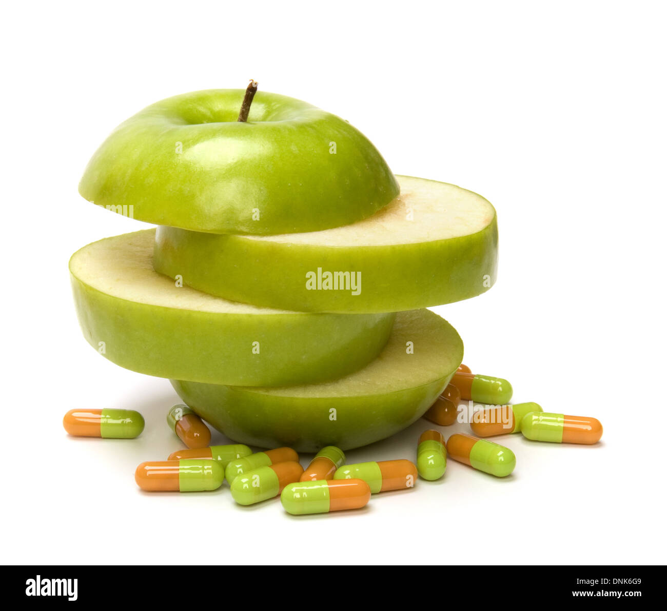 sliced apple and pills isolated on white background Stock Photo - Alamy