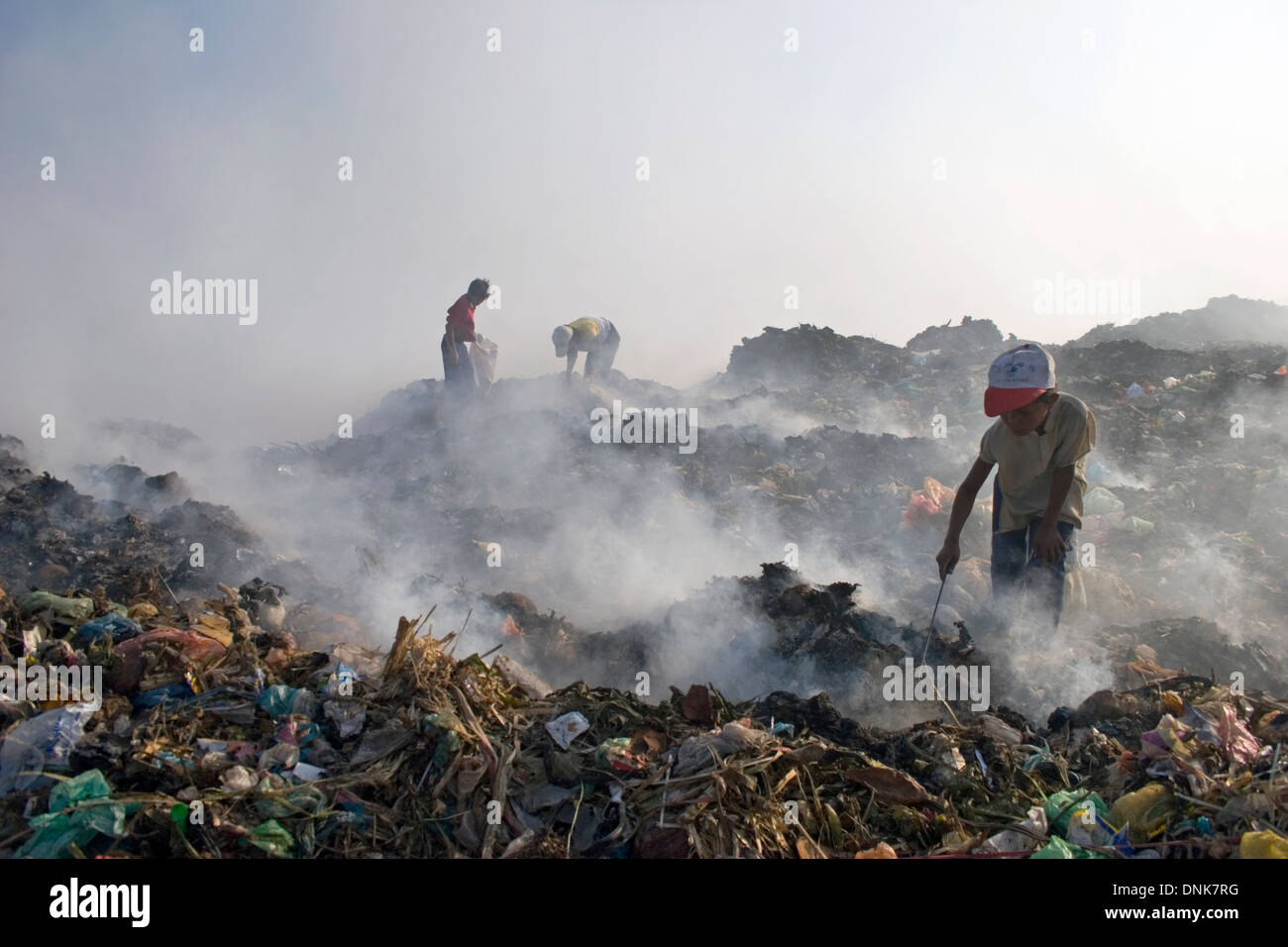 Young child laborer boys are collecting recyclable material at the ...
