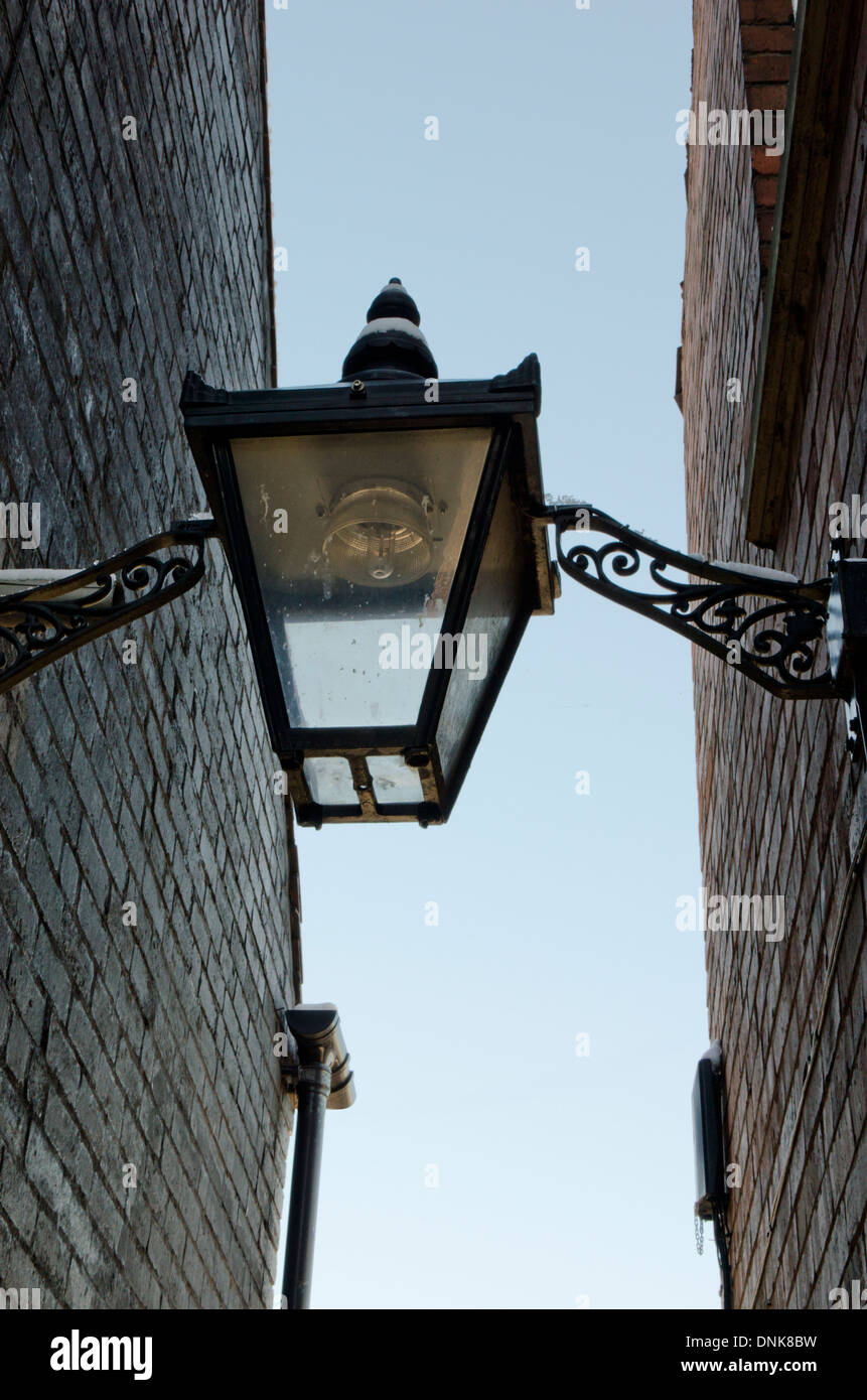 Old Victorian four-sided street light between two buildings Stock Photo ...