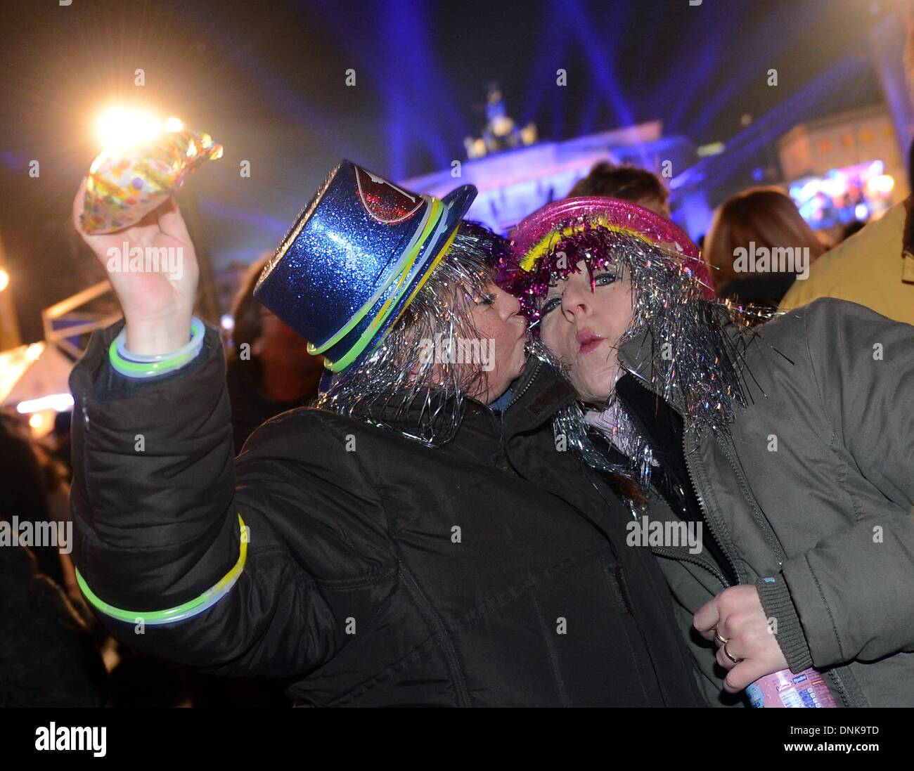 Berlin, Germany. 31st Dec, 2013. Two women wear glittery hats and wigs ...