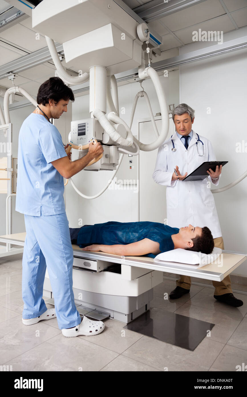 Radiologists Performing X-ray On Patient Stock Photo - Alamy