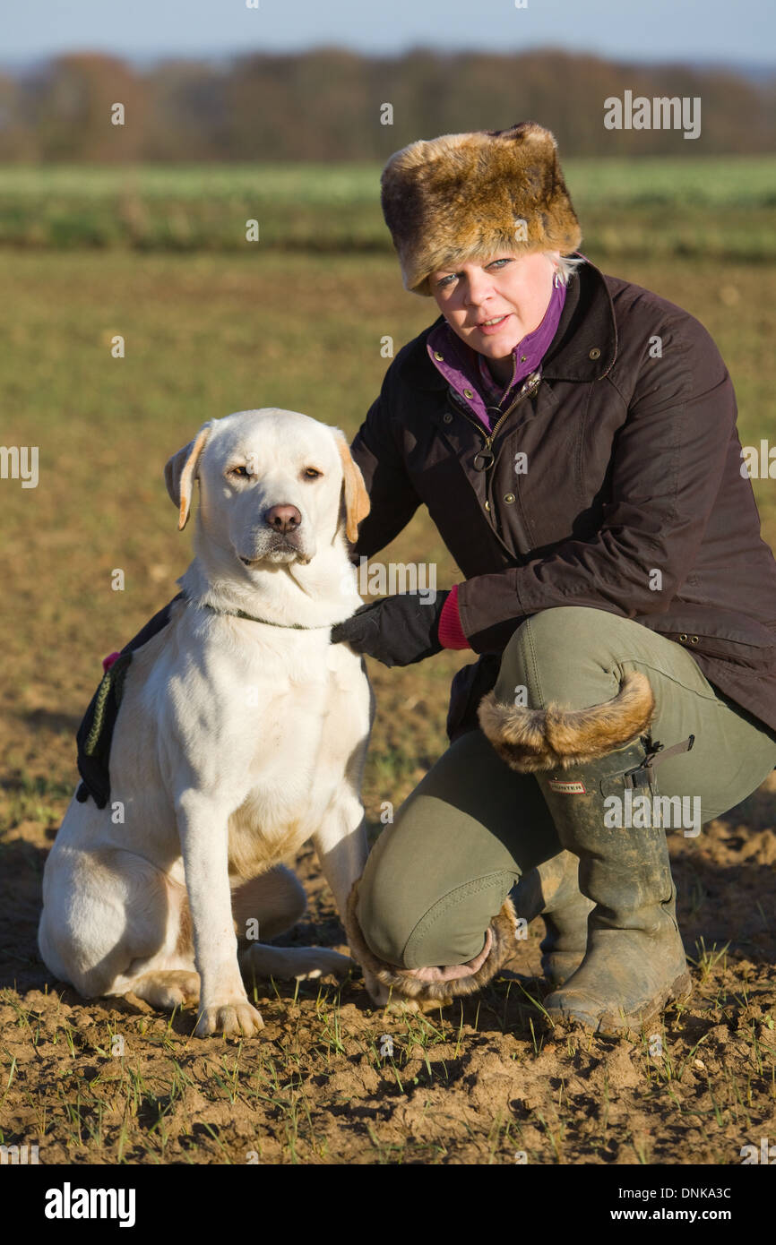 A Yellow Labrador Retriever dog with its female owner on a pheasant ...