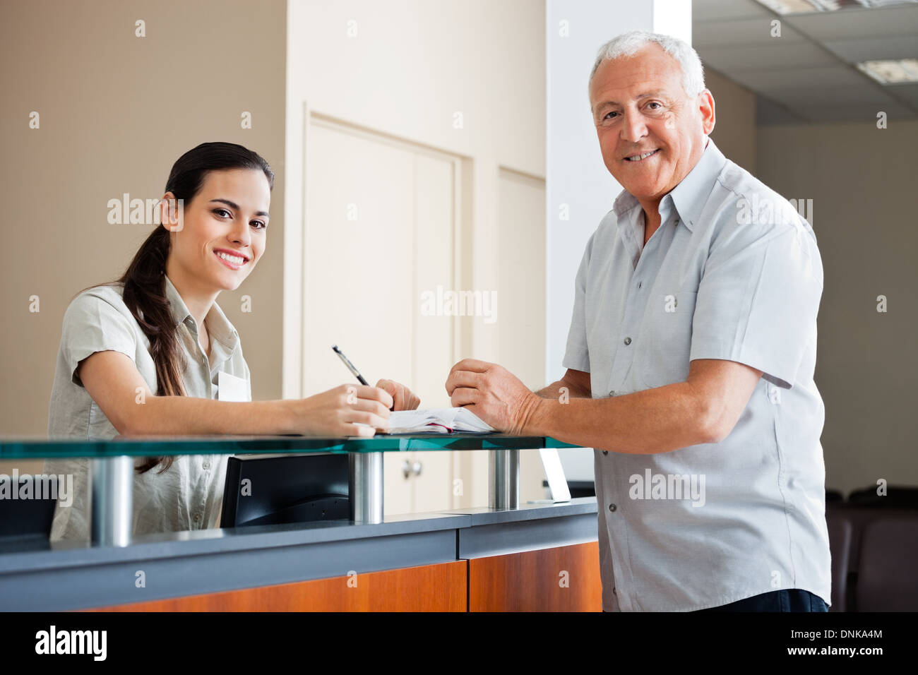 Senior Man Standing At Hospital Reception Stock Photo - Alamy