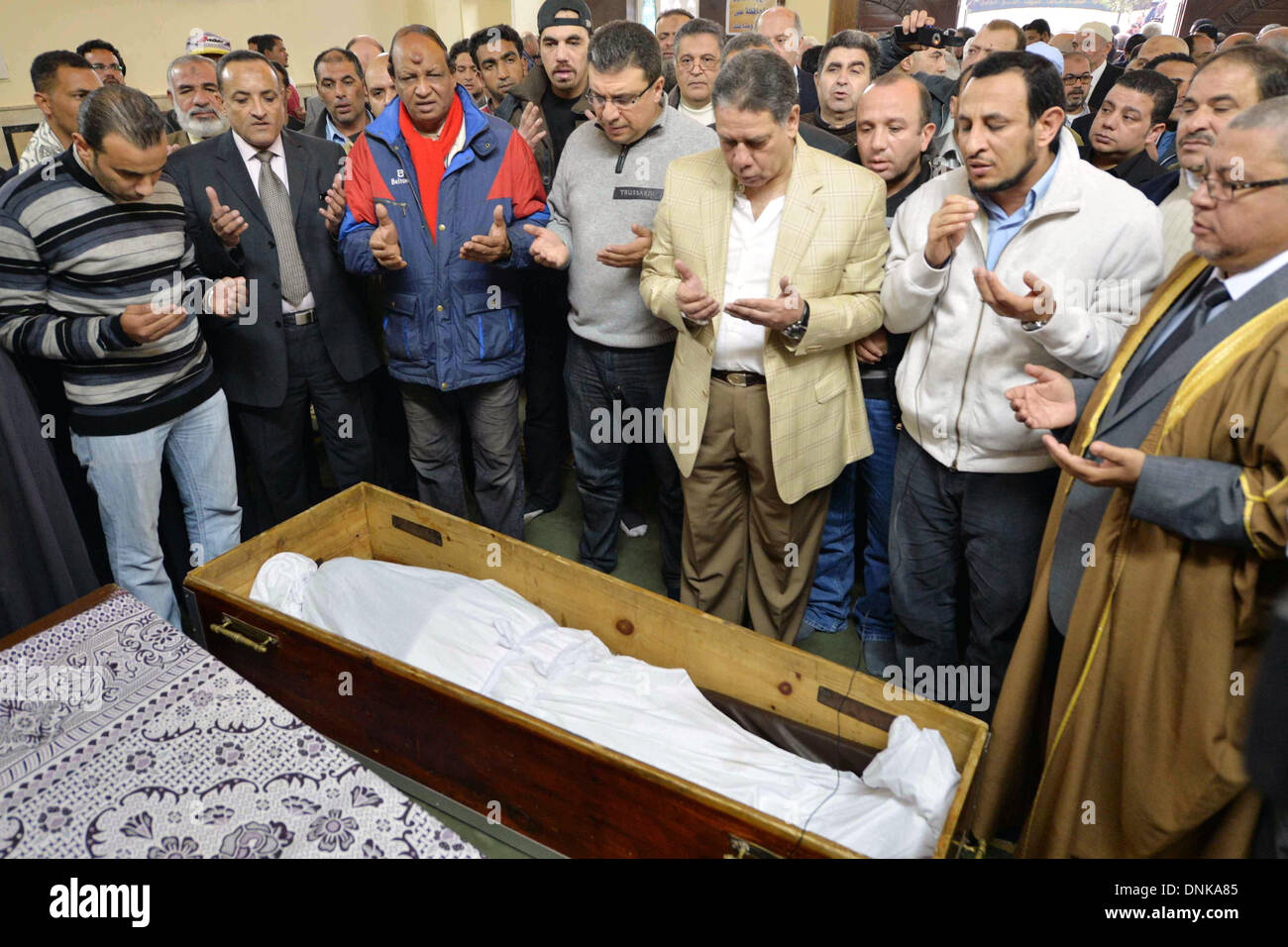 Cairo, Cairo, Egypt. 1st Jan, 2014. Egyptian mourners pray over the ...