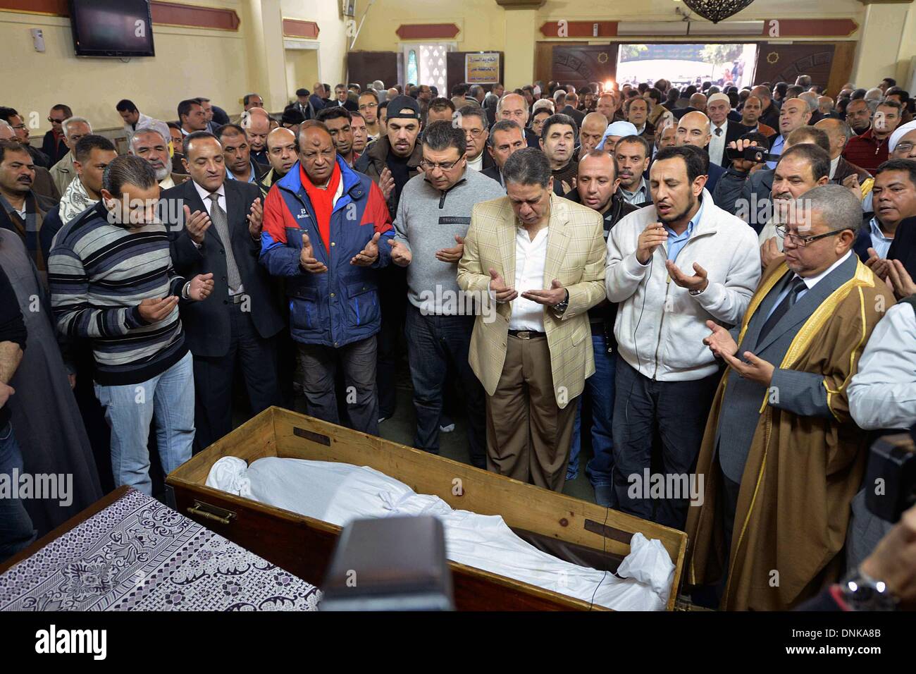 Cairo, Cairo, Egypt. 1st Jan, 2014. Egyptian mourners pray over the ...