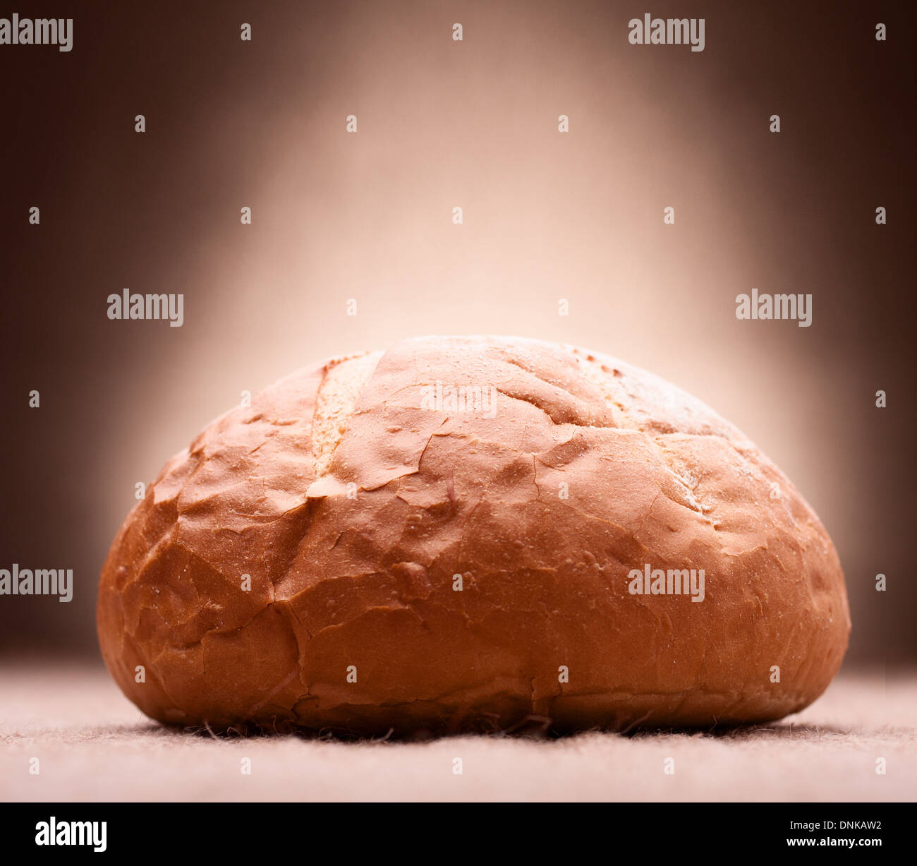 Loaf of wheat bread on rustic background Stock Photo - Alamy