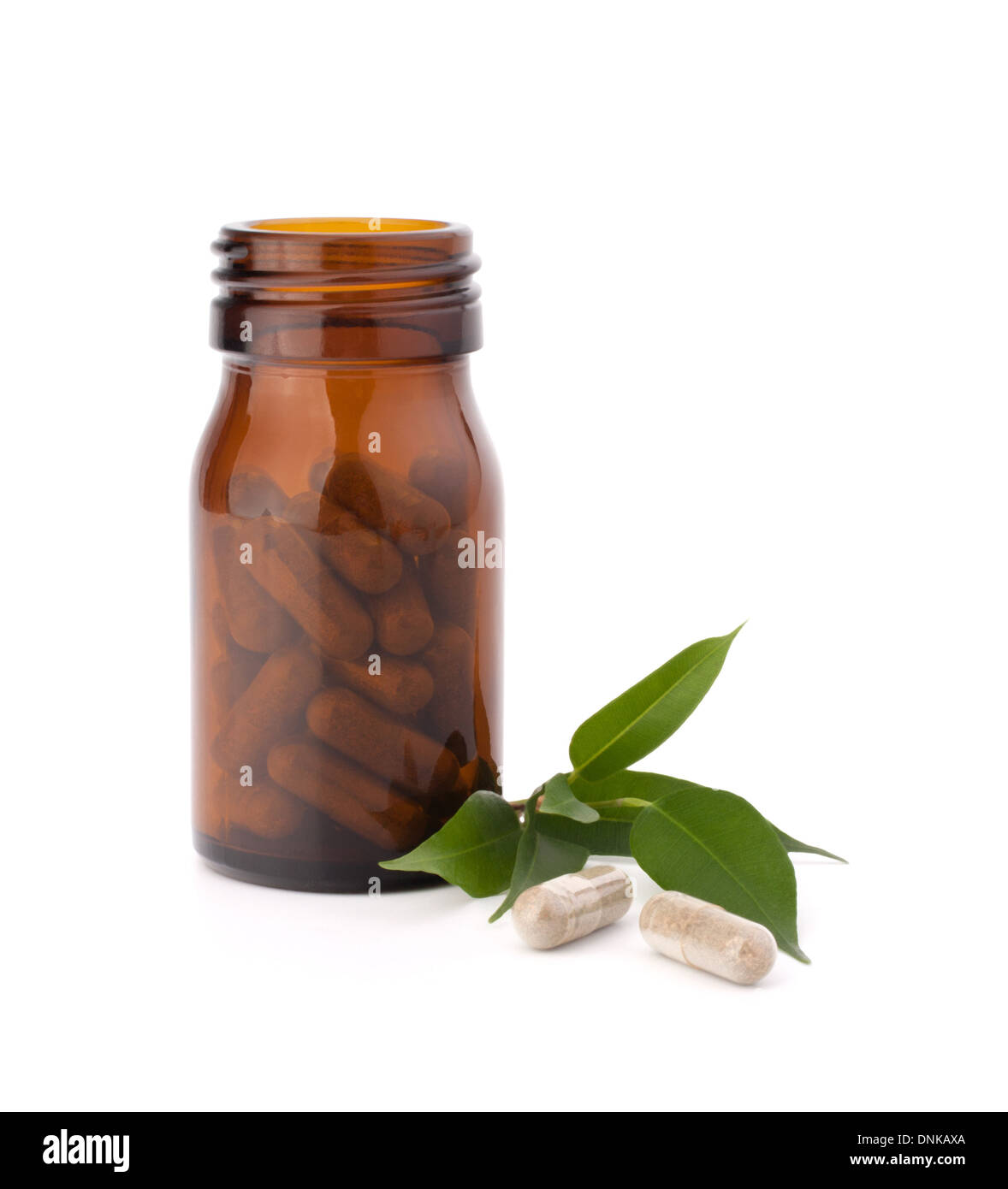 Herbal drug capsules in brown glass bottle isolated on white background ...