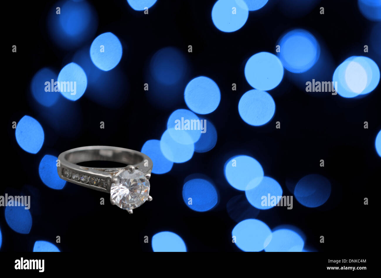 diamond engagement ring on abstract blue background Stock Photo - Alamy
