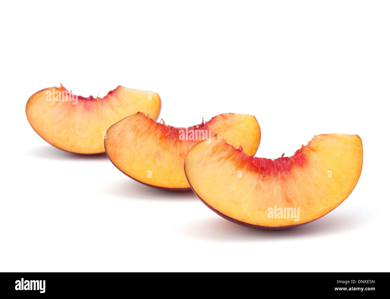 Nectarine fruit segments isolated on white background Stock Photo - Alamy