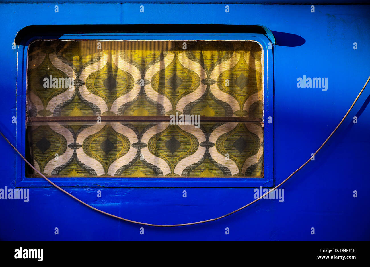 Window on a blue metal wall on a barge. landscape, nobody, close up ...