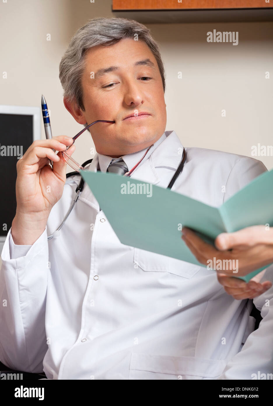 Doctor Reading Medical Report Stock Photo - Alamy