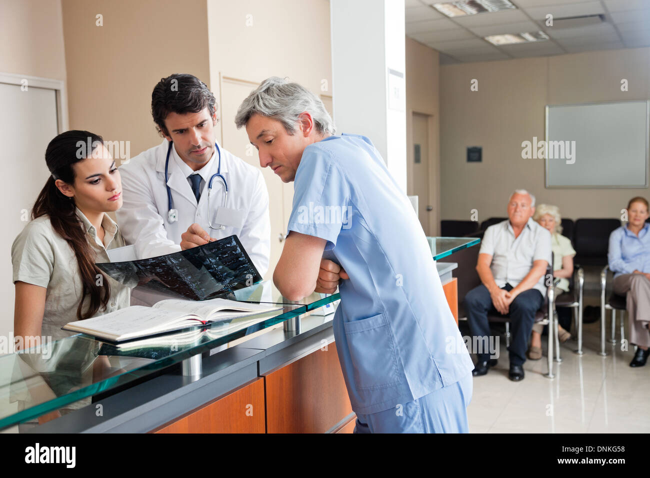 Doctors Reviewing X-ray At Reception Stock Photo - Alamy