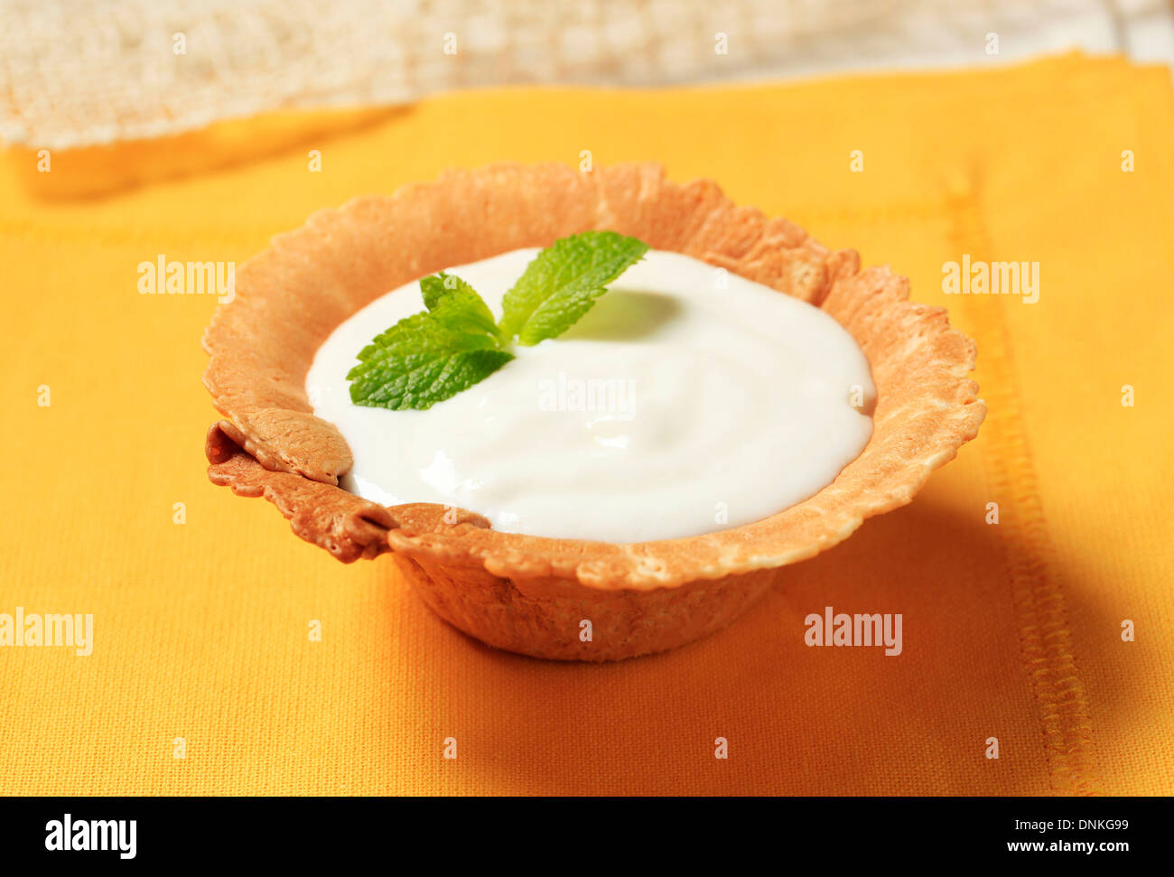 Wafer cup filled with lemon cream Stock Photo - Alamy
