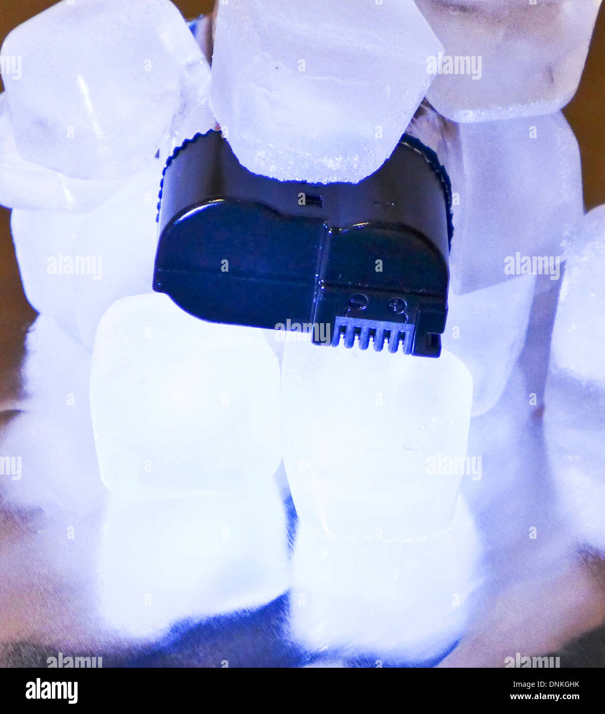 Nikon D7000 camera battery surrounded by ice blocks Stock Photo - Alamy