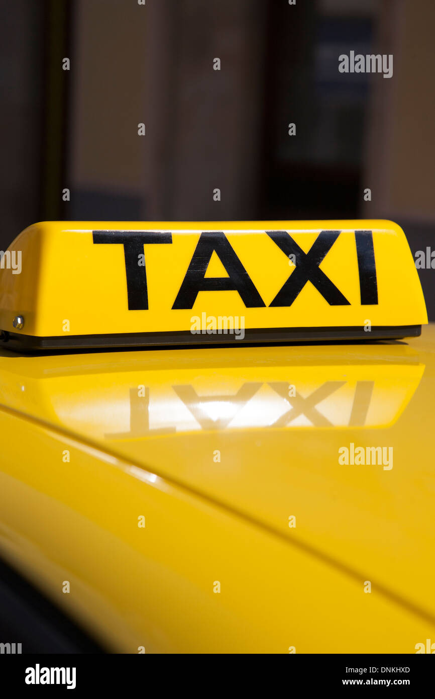 Yellow Taxi Sign on Top of Car Stock Photo - Alamy