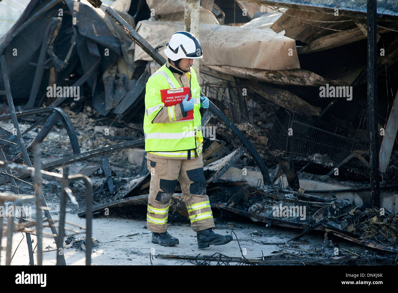 A fire investigator walks through the scene of a fire Stock Photo - Alamy